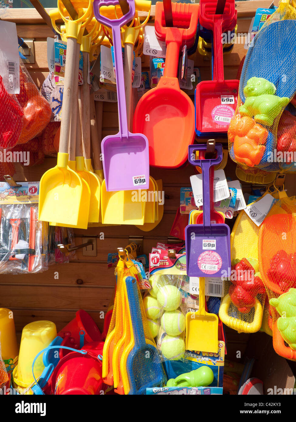 Seaside beach toys colourful plastic balls and spades Stock Photo - Alamy