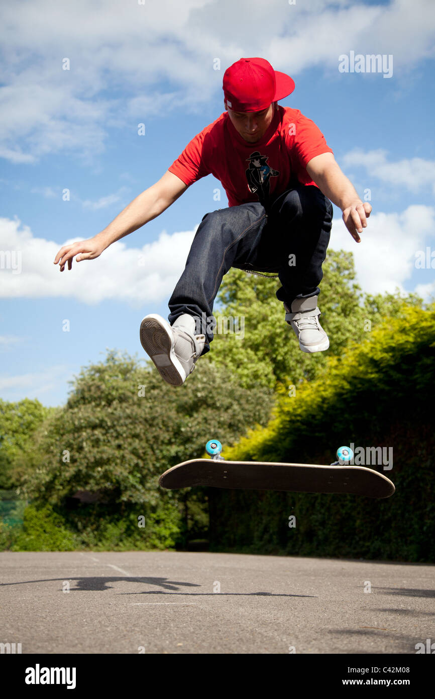Young skater preforming a huge flip trick Stock Photo - Alamy
