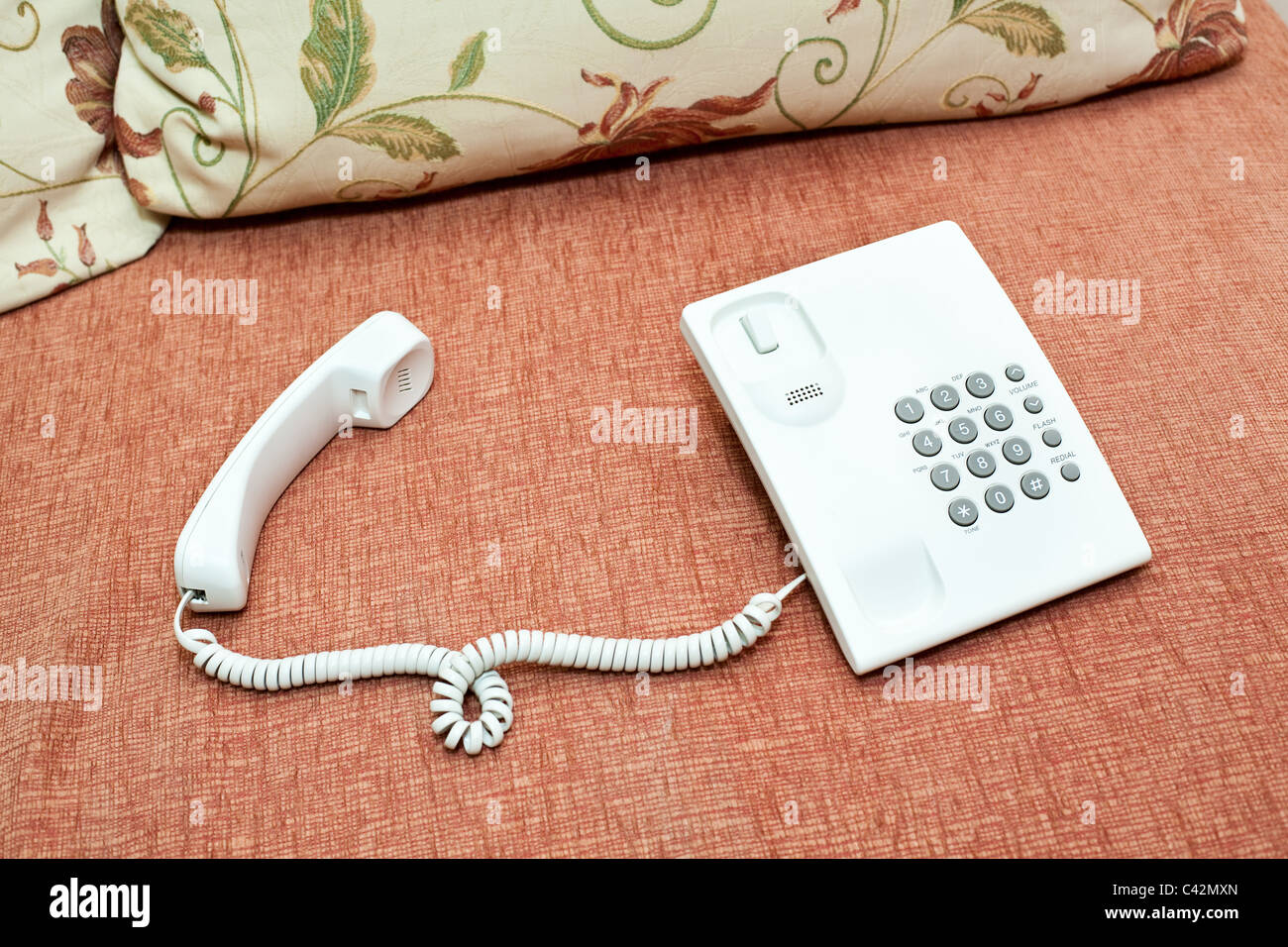 White telephone on sofa. Phone box not in focus. Handset in focus Stock ...