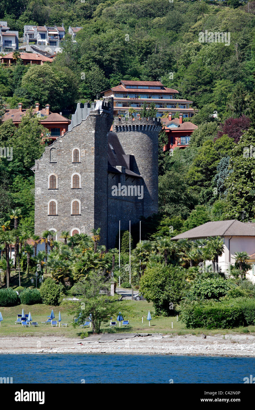 Restored ruins of an ancient castle with a beach and deck chairs on ...