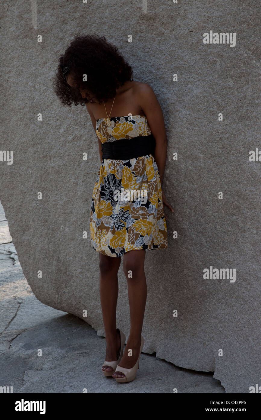 Pretty African American woman standing against a large stone Stock ...