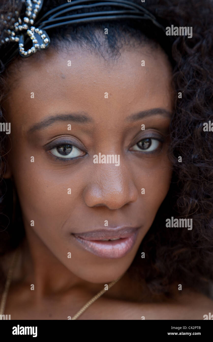 Pretty black woman with a friendly, sweet thoughtful and inviting ...