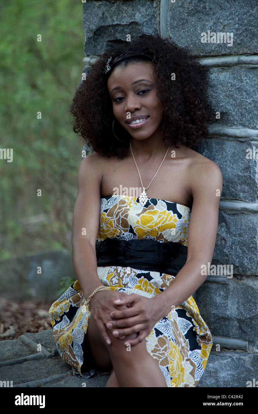 Pretty black woman with a serious and pensive expression, sitting ...