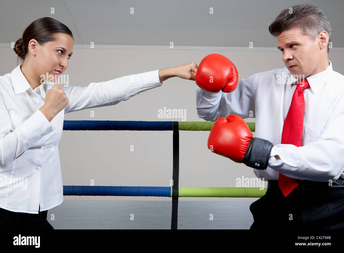 Portrait of aggressive businessman in boxing gloves fighting with ...
