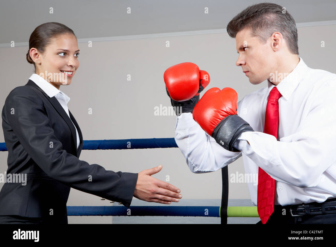 Portrait of aggressive businessman in boxing gloves fighting with ...