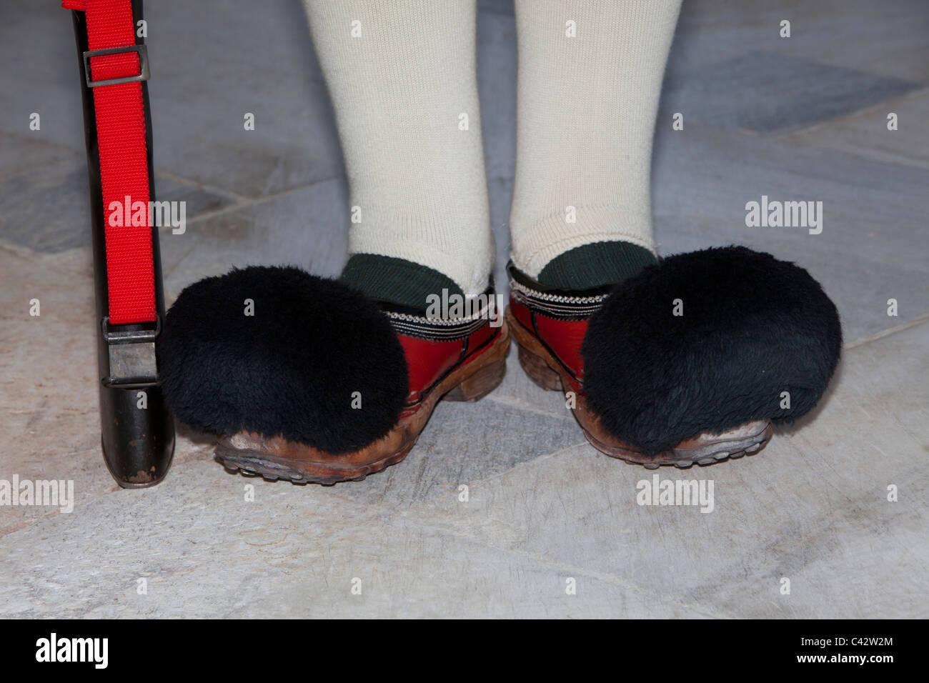 Red tsarouhi leather clogs with a black pompon of the Evzones at the ...