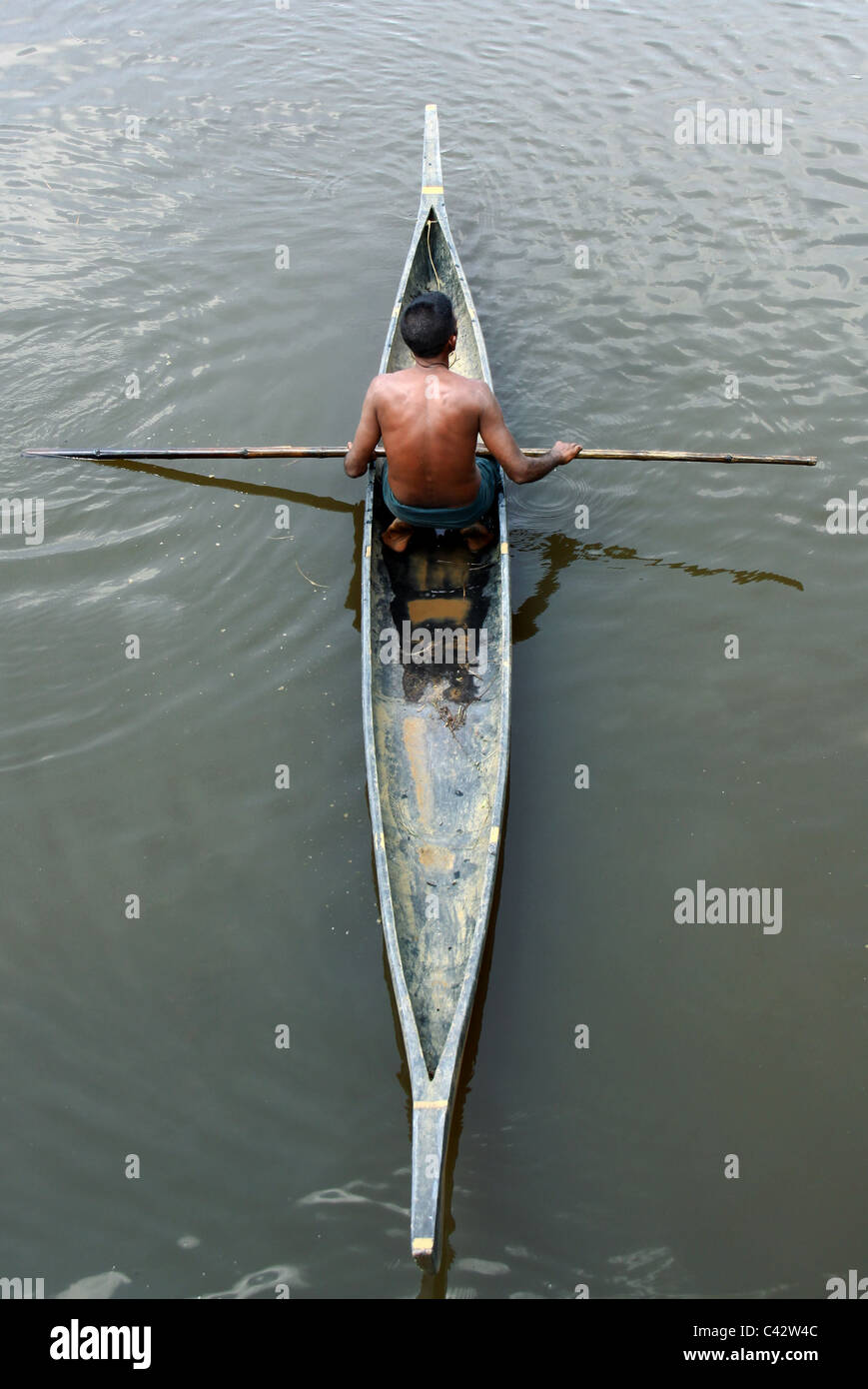 Man rowing traditional Kerala style small boat In Alleppey, Kerala ...
