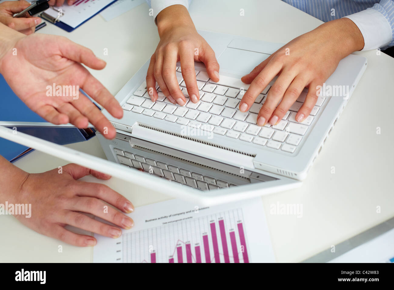 Human hands on keypad of laptop at workplace Stock Photo - Alamy