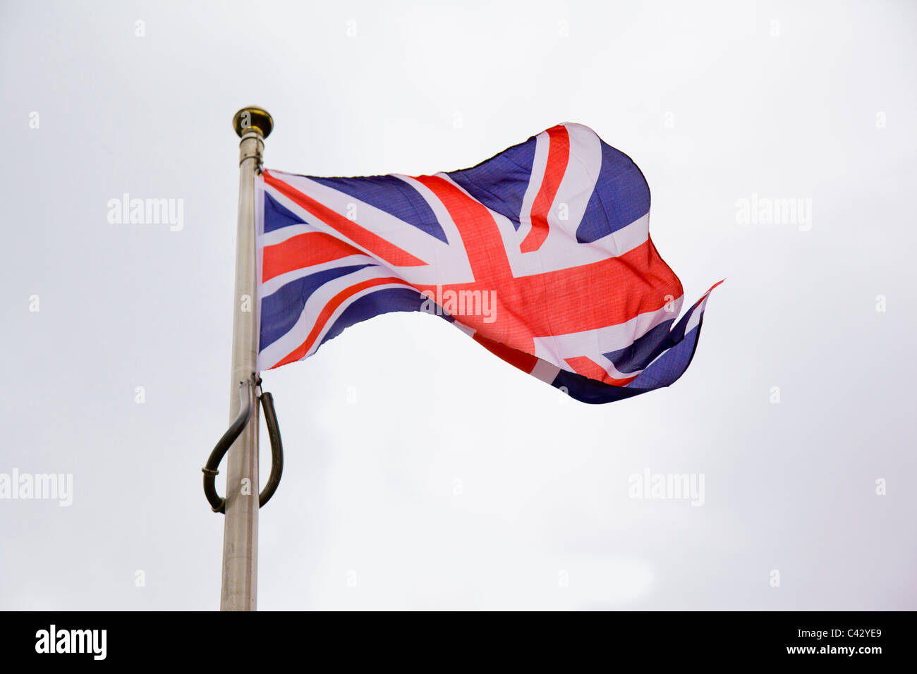 Union Jack flying in the breeze at the top of a flagpole Stock Photo ...