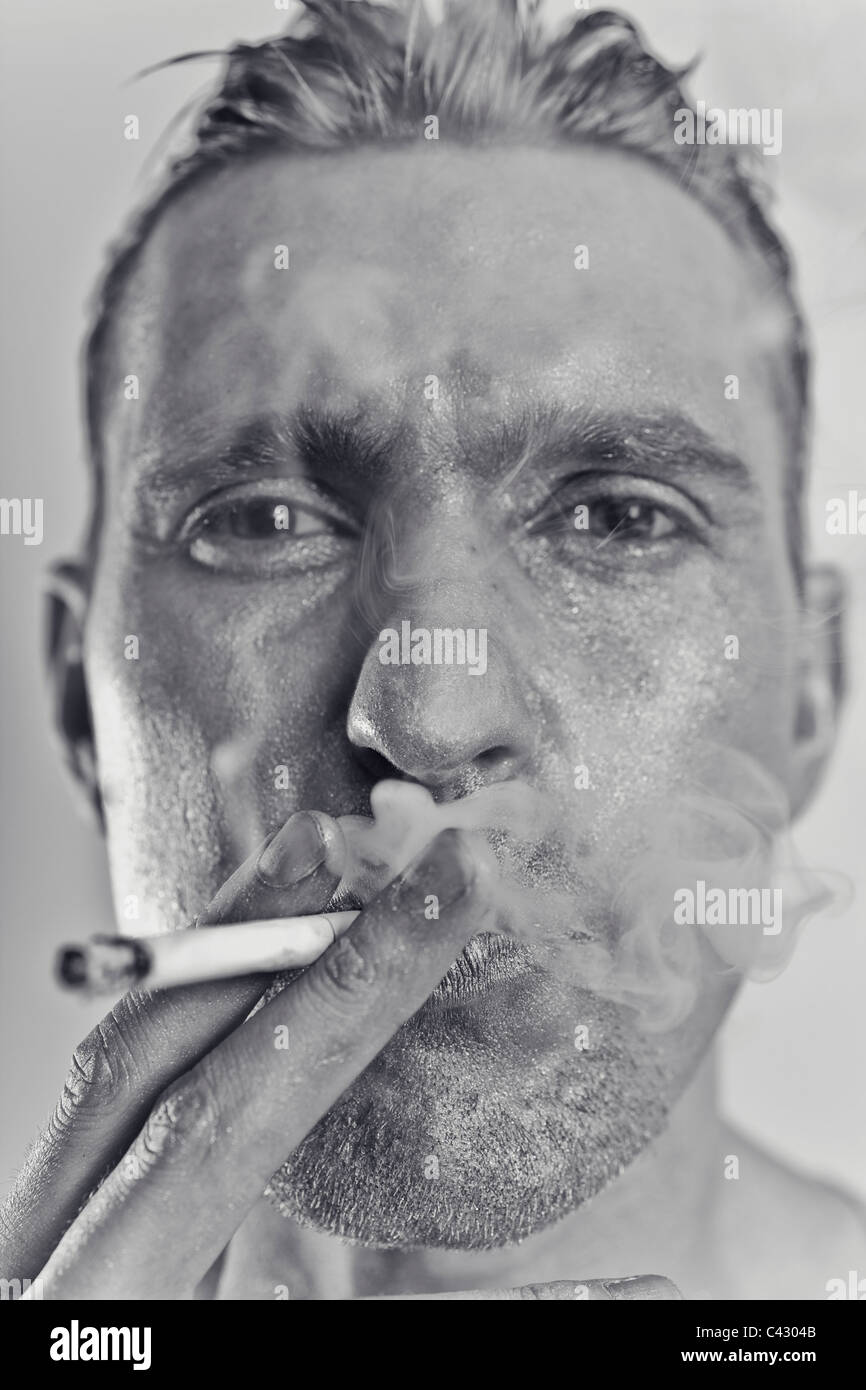 monochrome portrait of young attractive man with a silvery makeup with ...