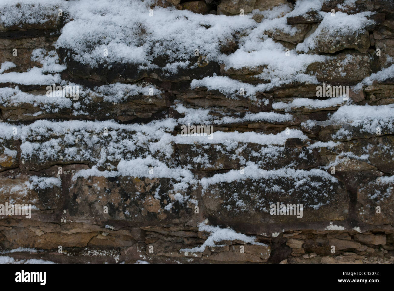 Stone wall with dusting of snow Stock Photo - Alamy
