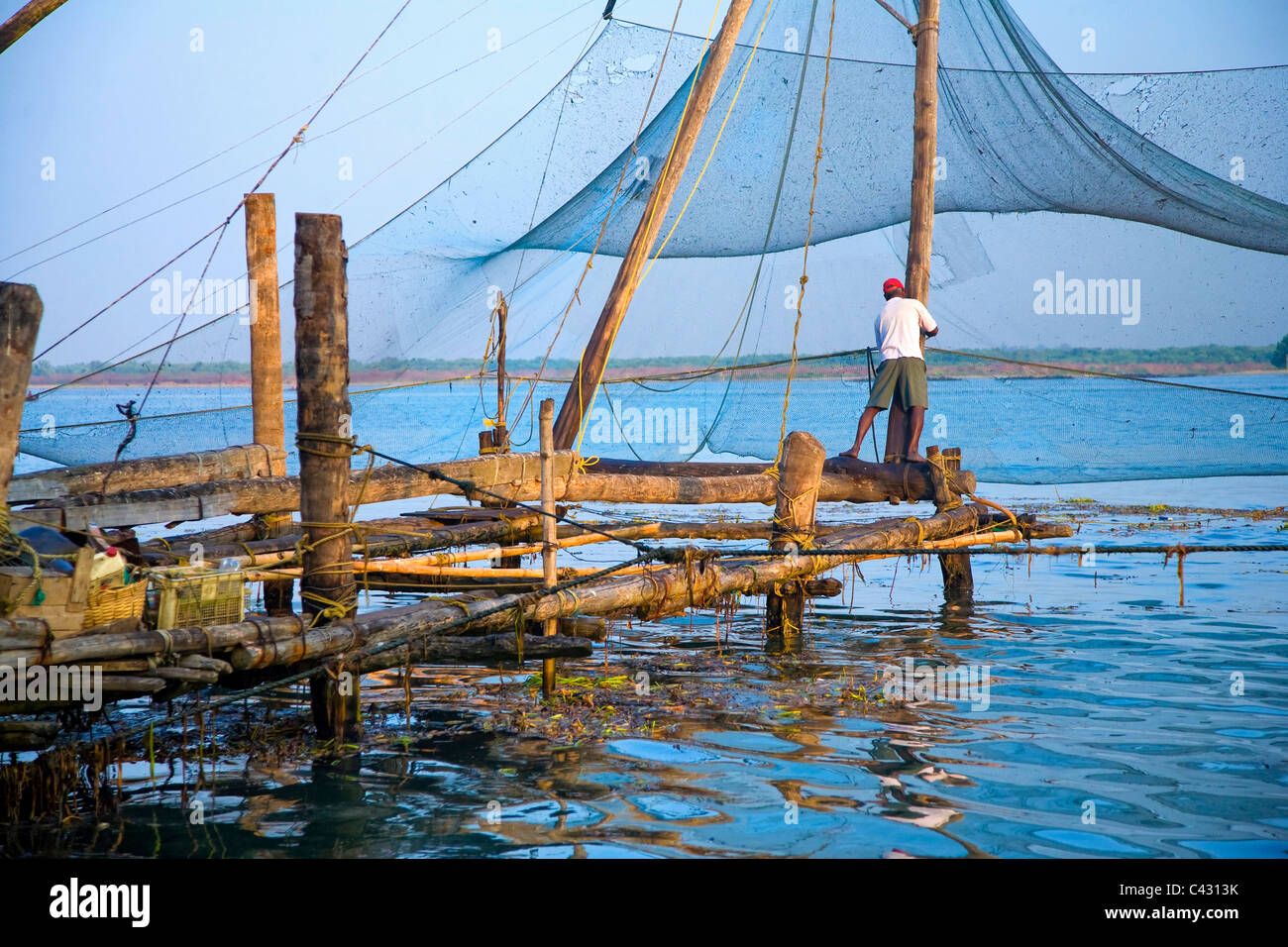 Fishermen and traditional fishing nets, Fort Cochin, Kerala Stock Photo ...