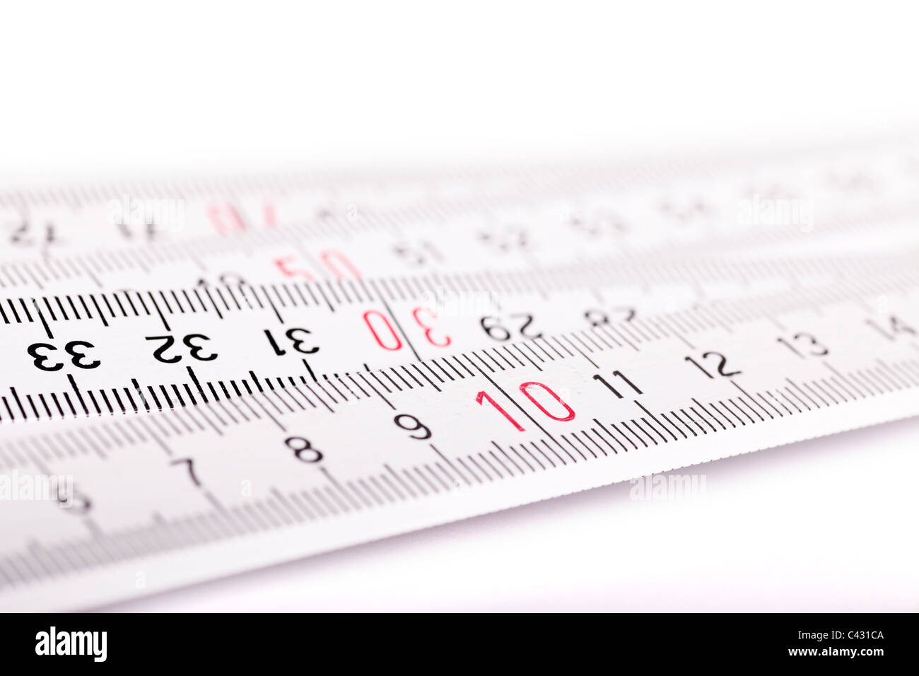 white folding rule over white Background Stock Photo - Alamy