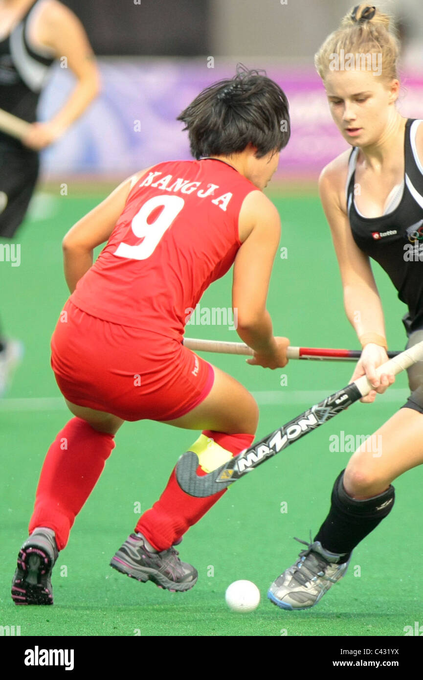 South Korea's Kang Jina(center) tries to find a way past New Zealand's ...