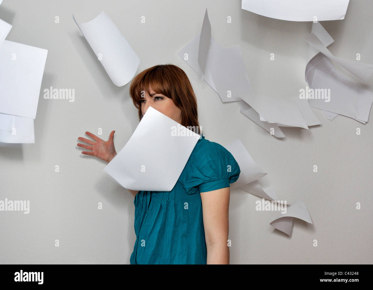 Young woman throwing paperwork in air Stock Photo - Alamy
