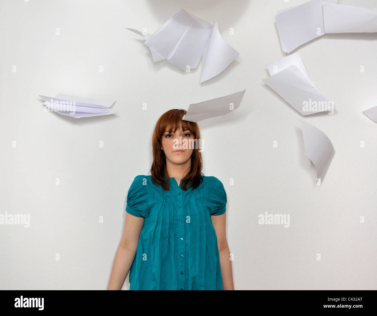 Young woman throwing paperwork in air Stock Photo - Alamy