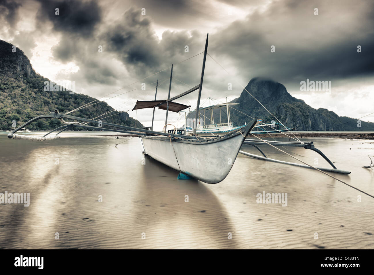Traditional philippine boat bangka at sunset time Stock Photo - Alamy