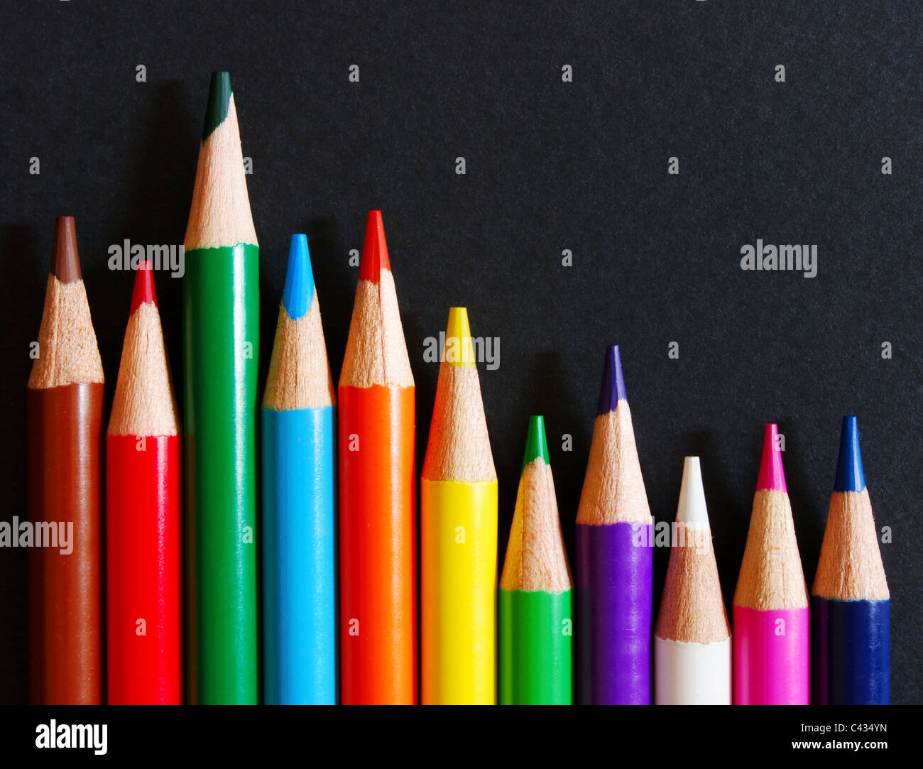 Color pencils photographed on rough black paper Stock Photo - Alamy