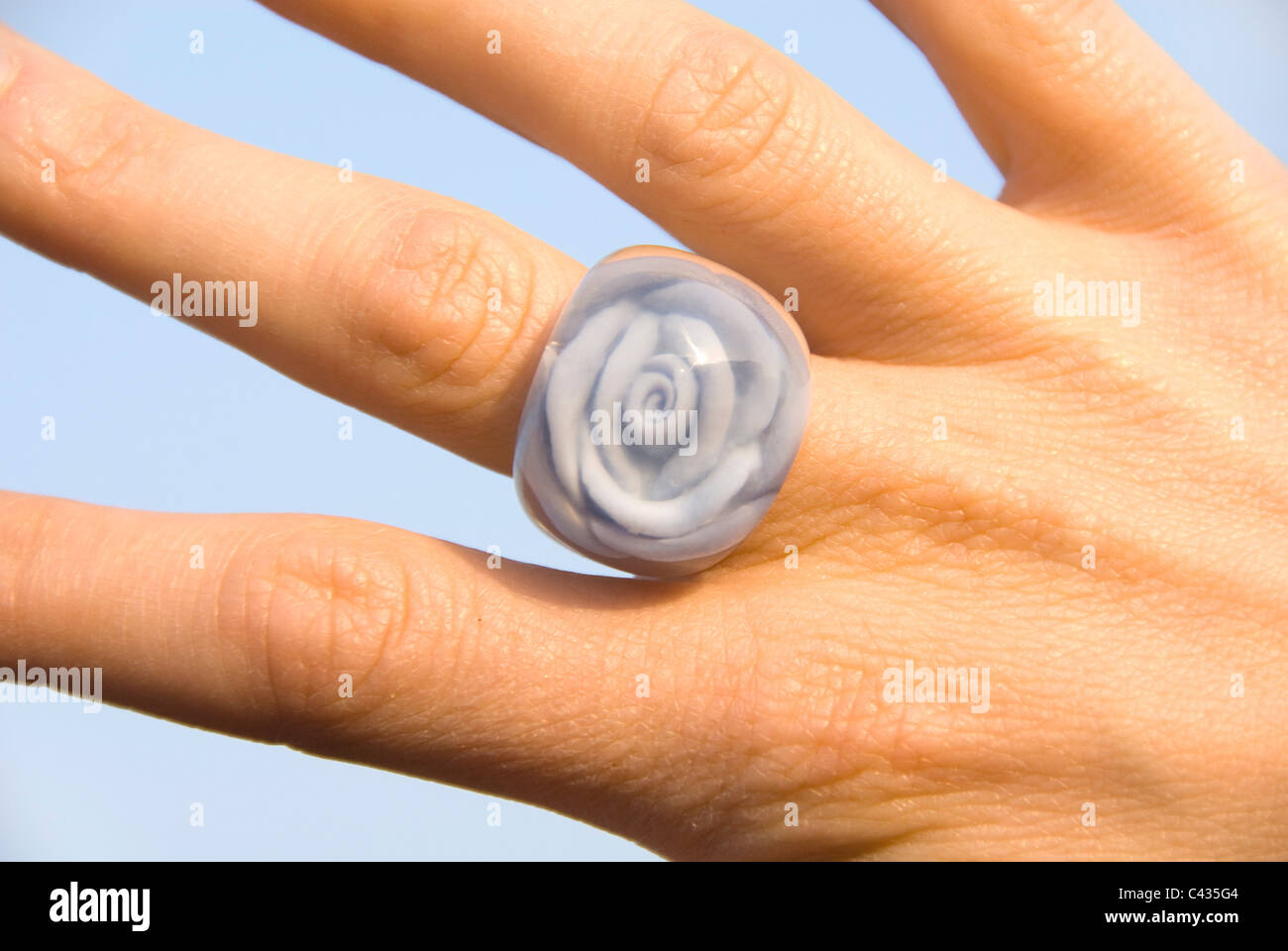 Flower ring on finger Stock Photo - Alamy