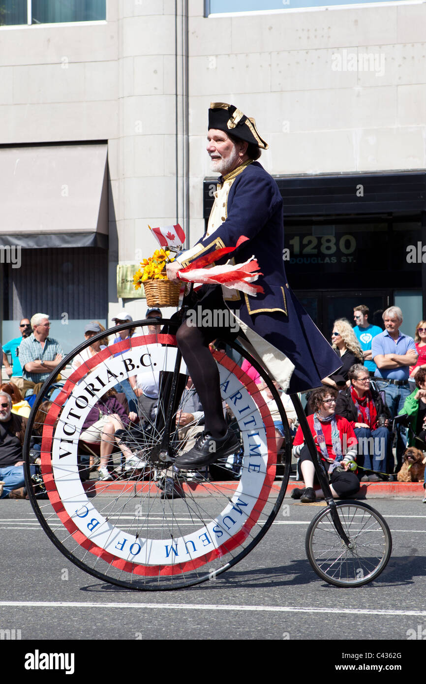 A man riding a penny-farthing bicycle during the Victoria Day parade in ...