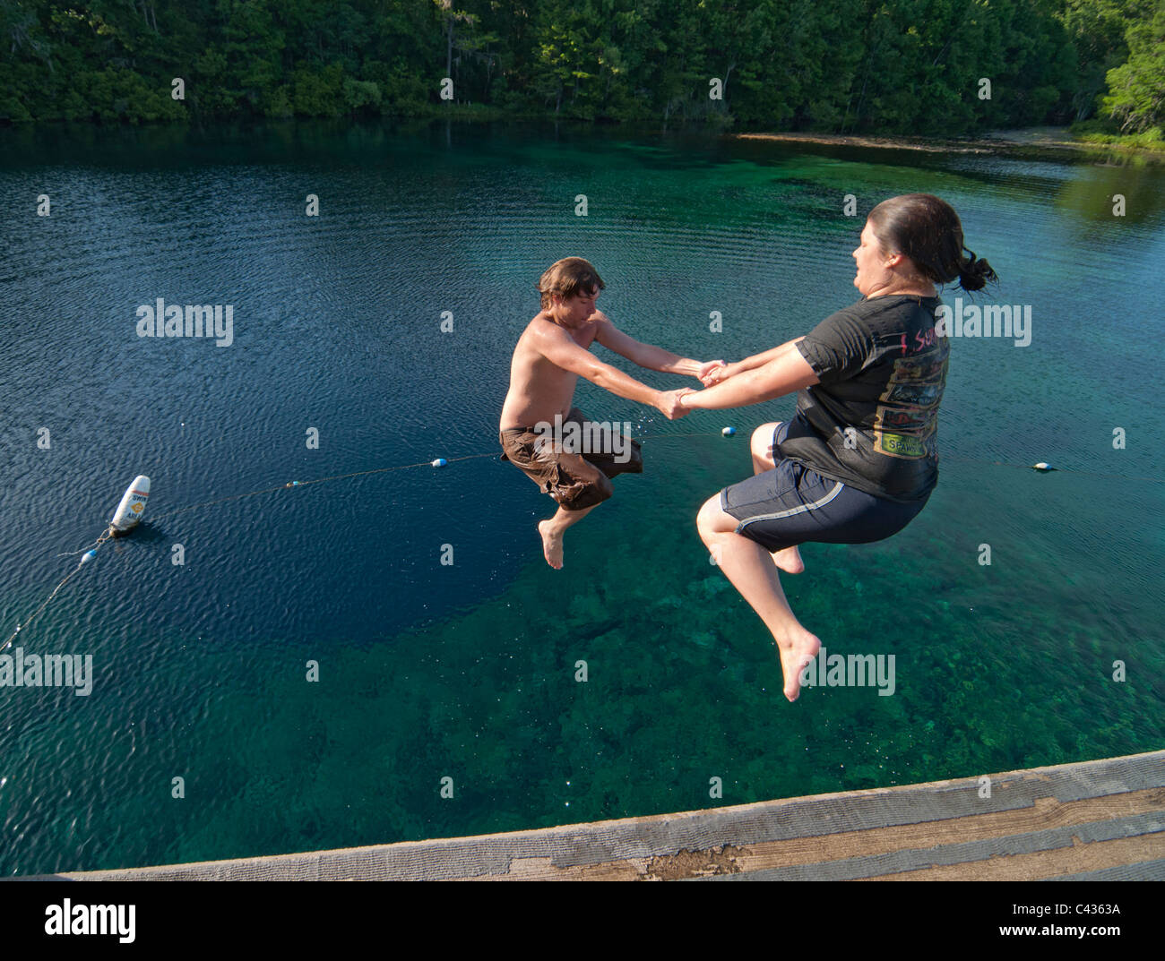 Couple leaping from the high tower into the main spring at Edward Ball ...
