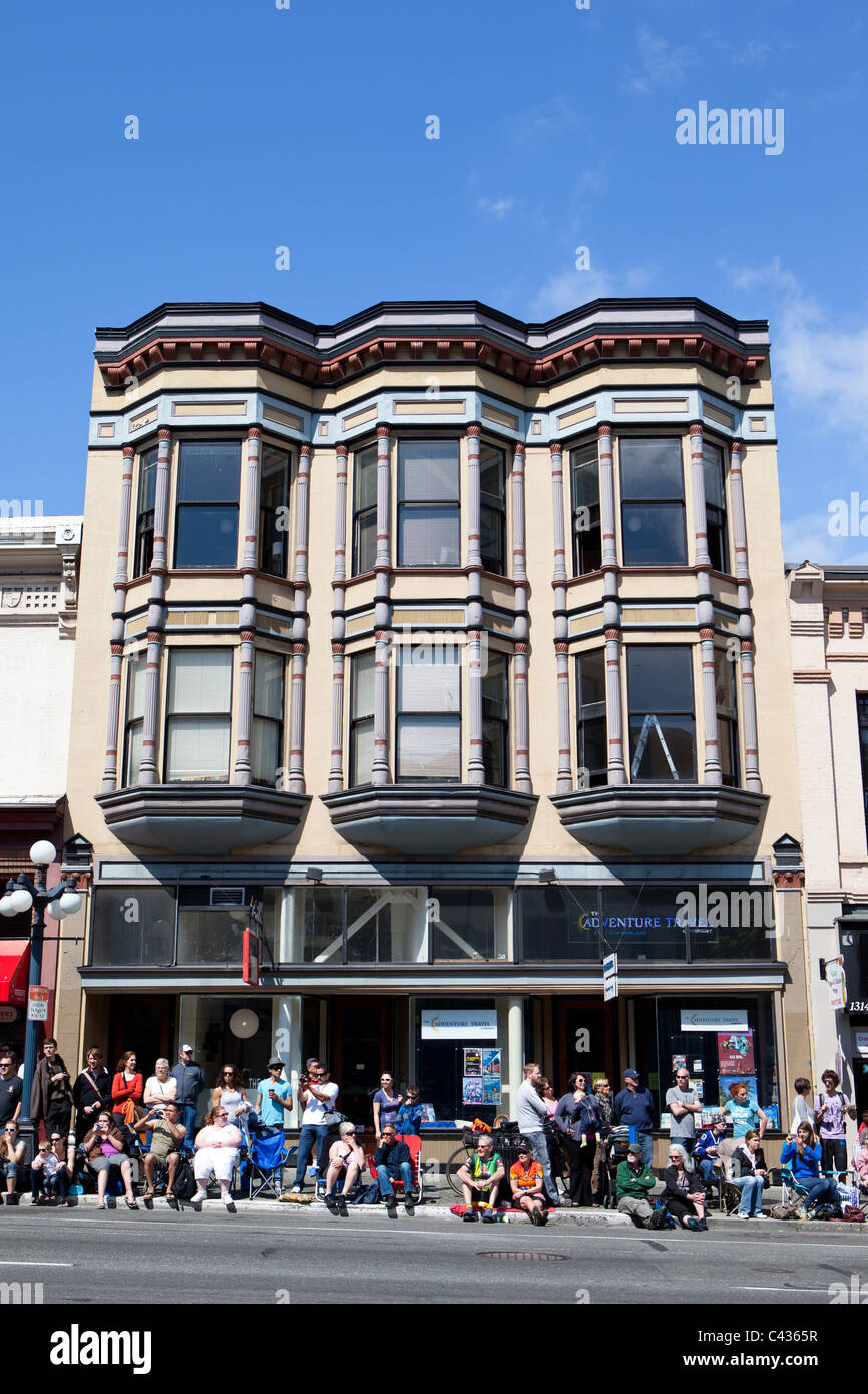 People on the side of Douglas Street watching the Victoria Day parade ...