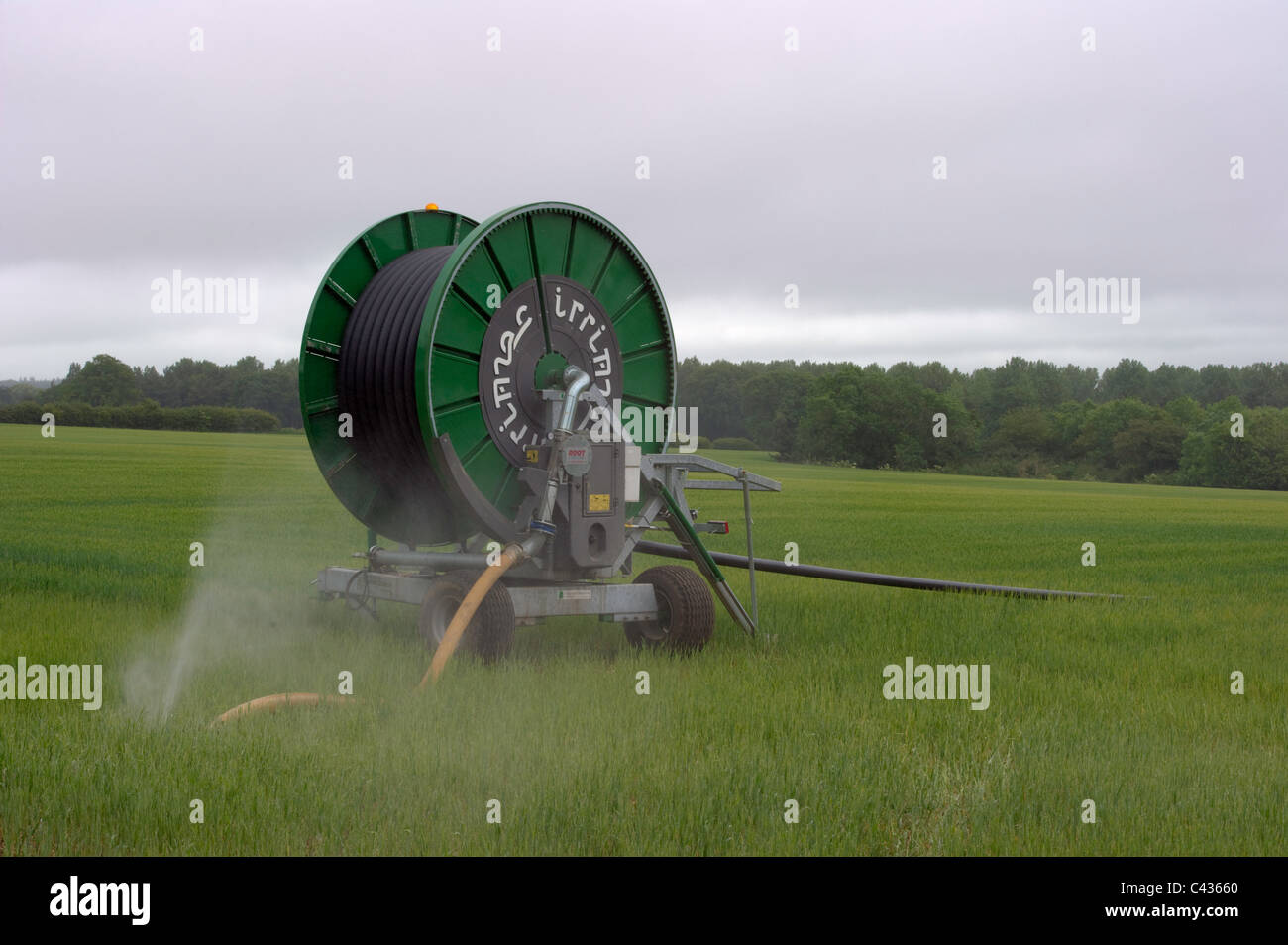 Farmland irrigation system with leaking pipe Stock Photo - Alamy