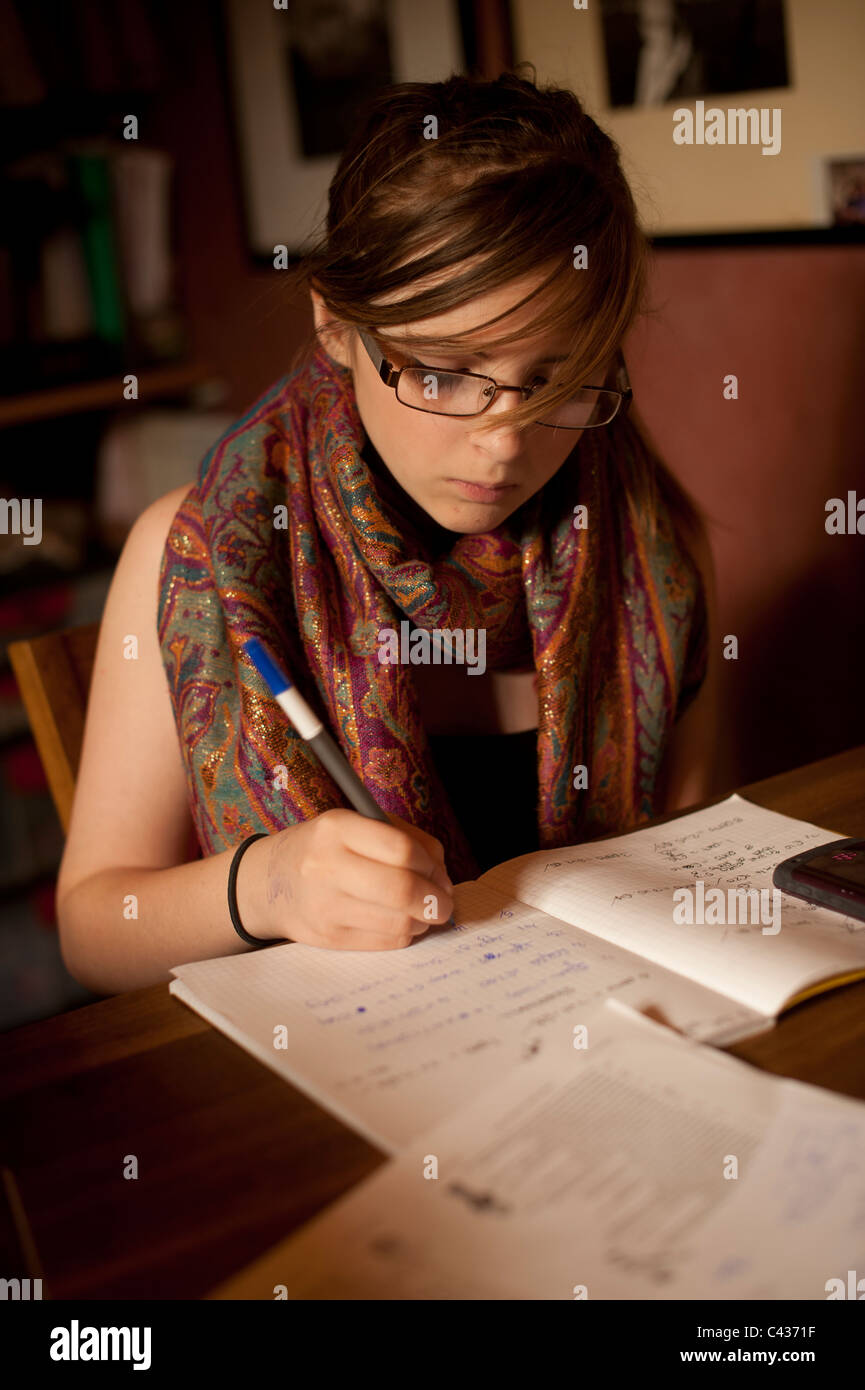 A 12 13 year old girl doing her mathematics homework at home UK Stock ...