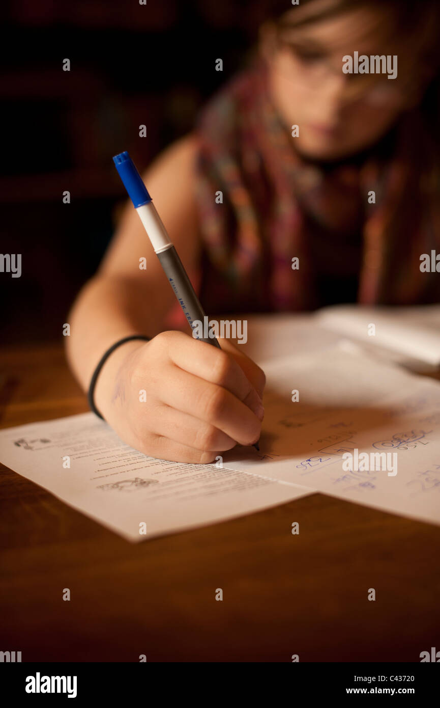 A 12 13 year old girl doing her mathematics homework at home UK Stock ...