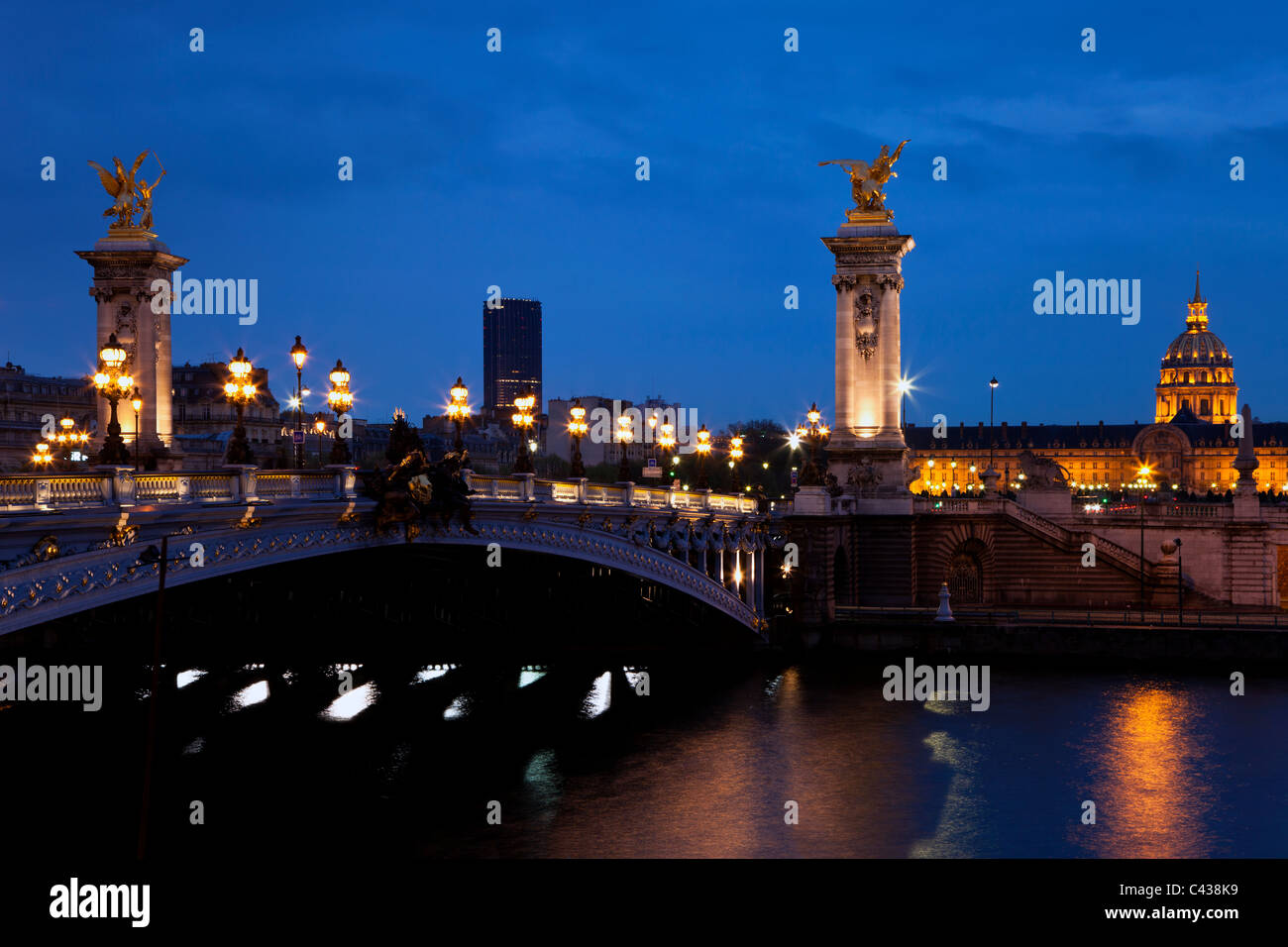 The Alexander III bridge and the Dome of Invalides at night. Paris ...