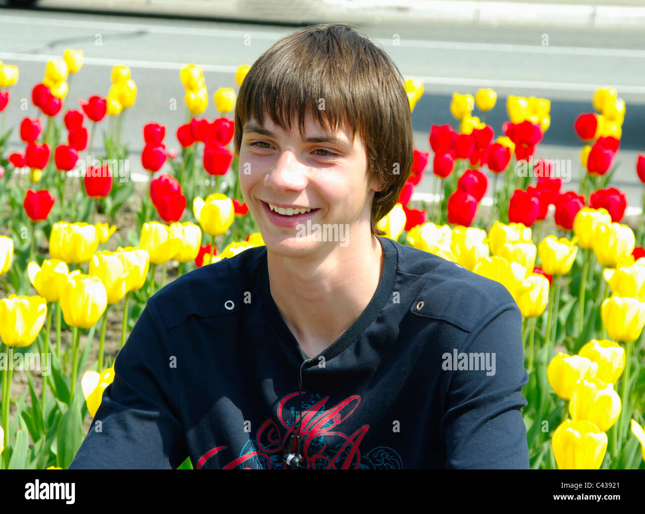 young boy and multi colored tulips on background Stock Photo - Alamy