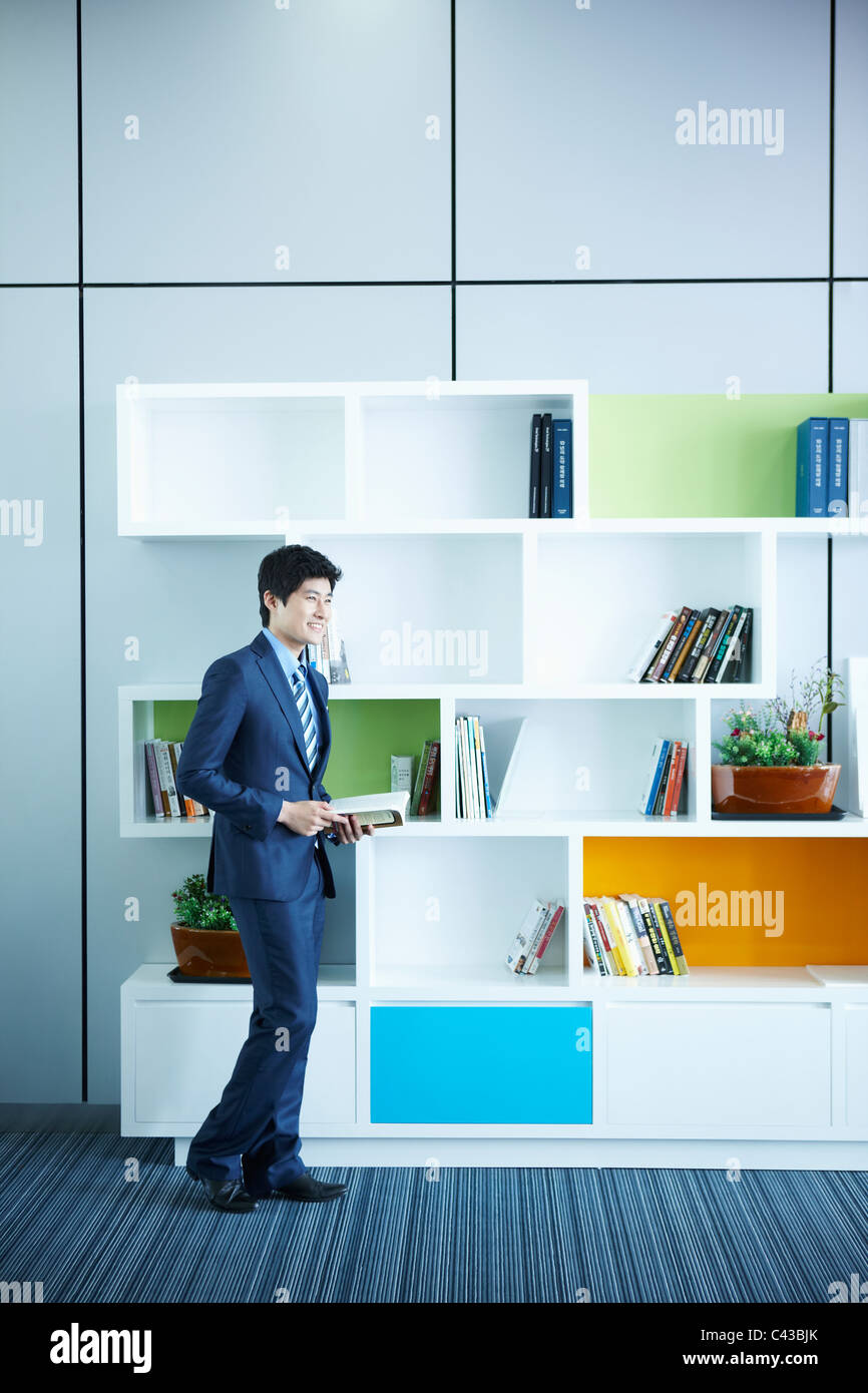 man holding book in office Stock Photo - Alamy
