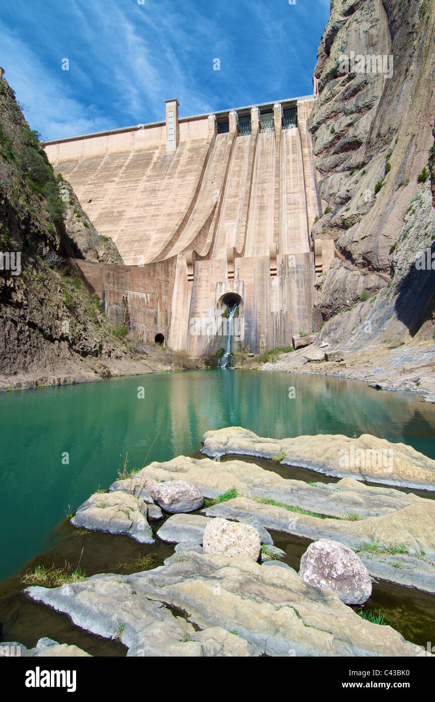 Hydroelectric dam with cloudy sky and round stones in Spain Stock Photo ...