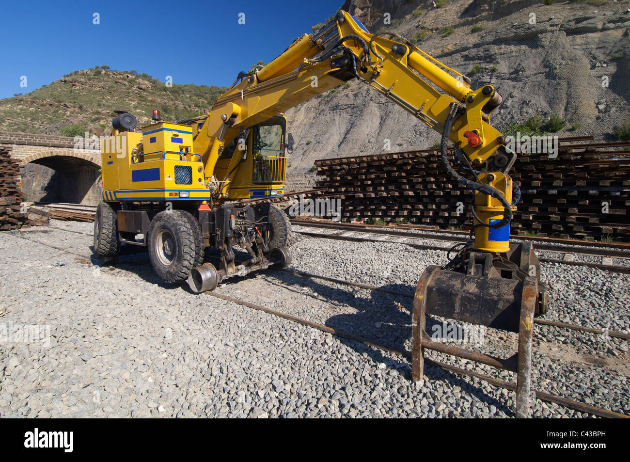 yellow machine repair train tracks Stock Photo - Alamy