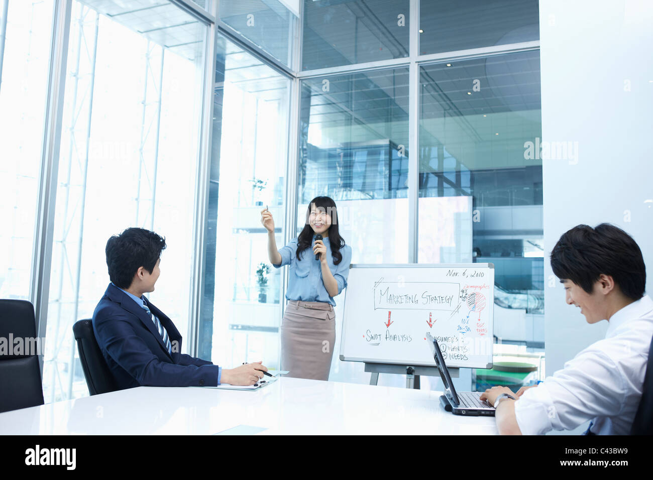 woman doing presentation to people in meeting room Stock Photo - Alamy