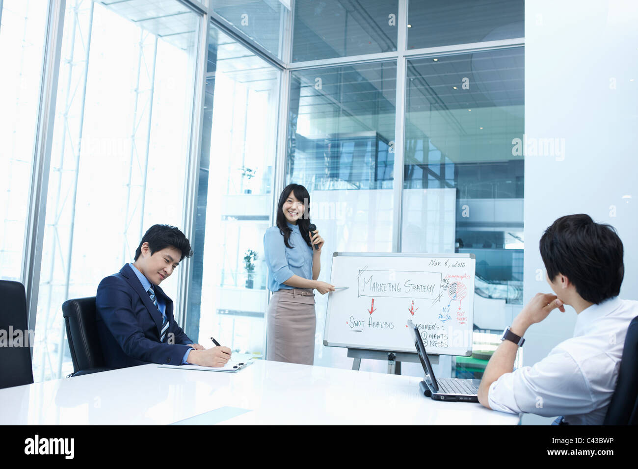woman doing presentation to people in meeting room Stock Photo - Alamy