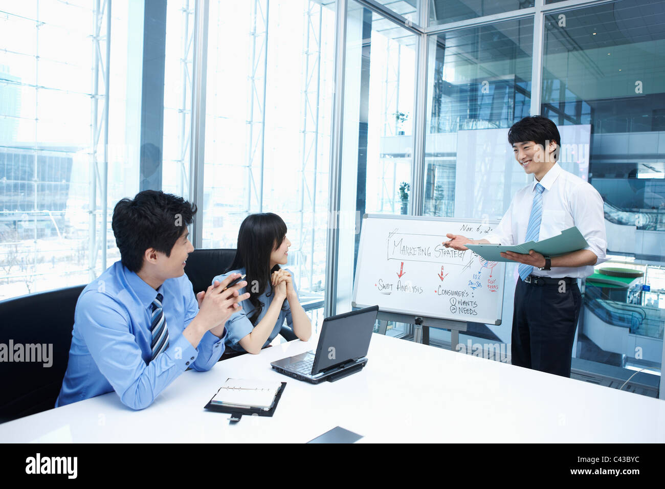 woman doing presentation to people in meeting room Stock Photo - Alamy