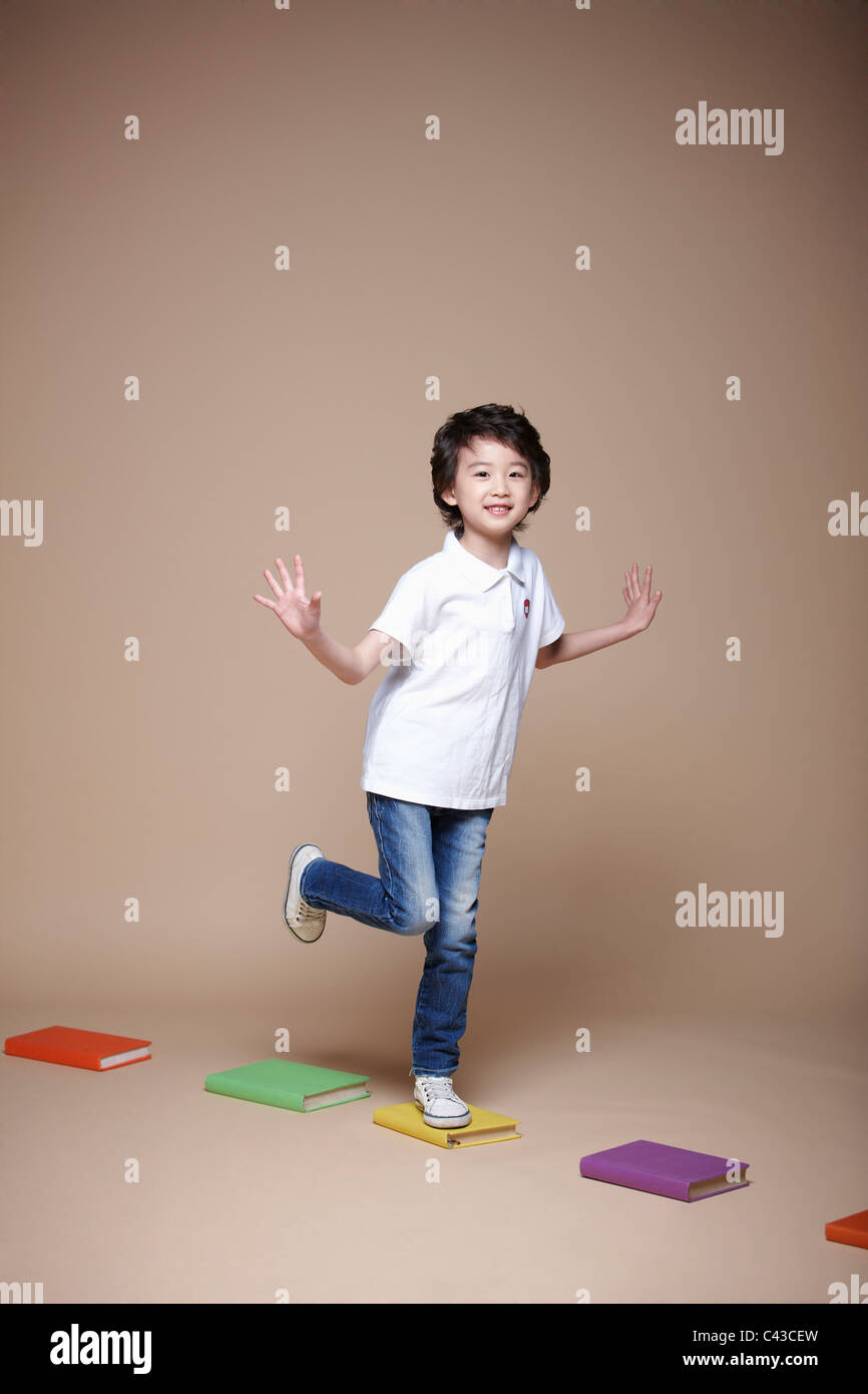 boy crosses stepping stones Stock Photo - Alamy