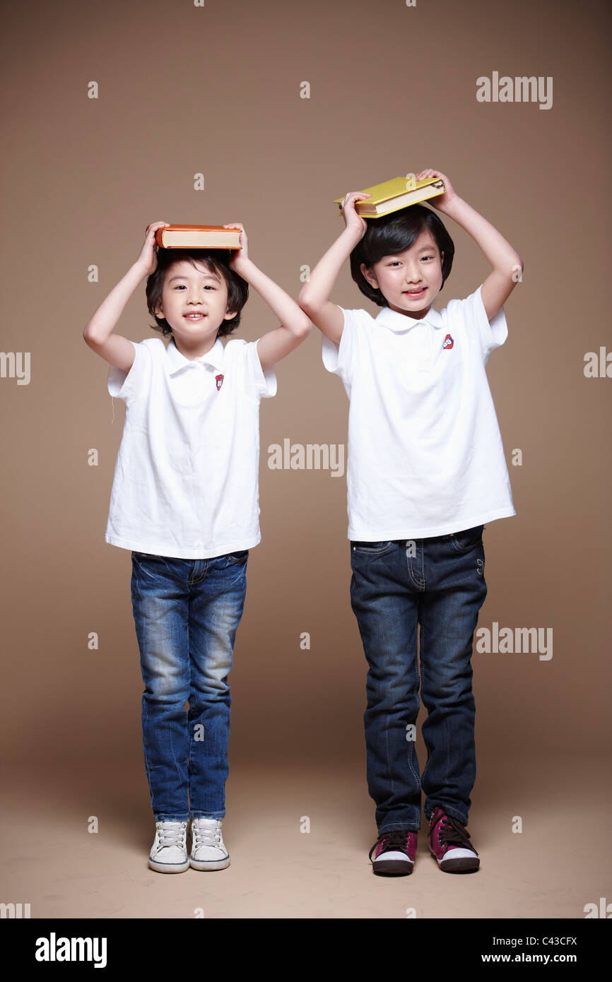 children balancing a book on their head Stock Photo - Alamy