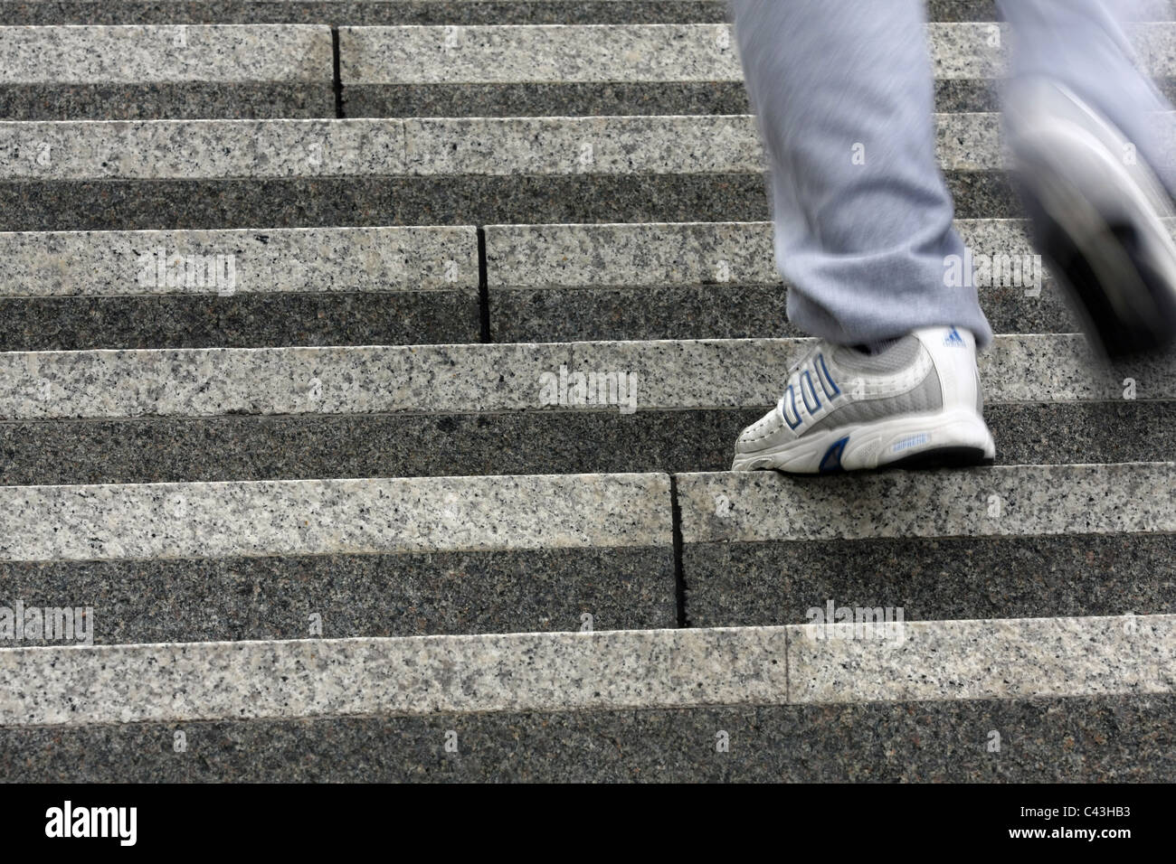 The legs of a male walking up some steps Stock Photo - Alamy