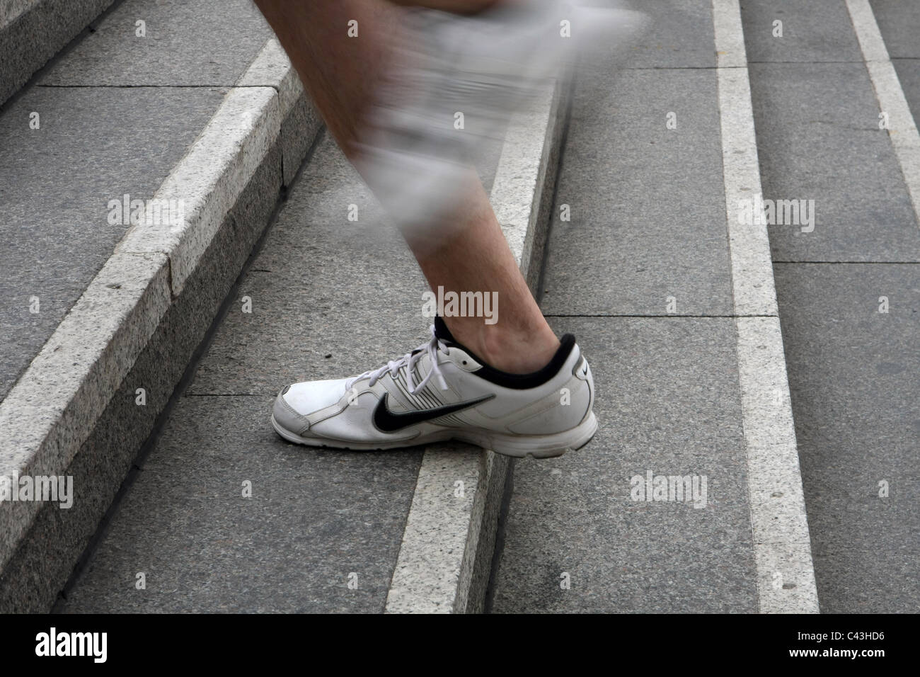 The legs of a male running up some steps Stock Photo - Alamy