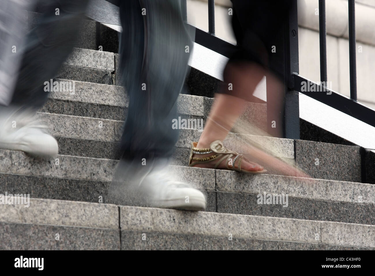 The legs of a male and female walking down some steps Stock Photo - Alamy