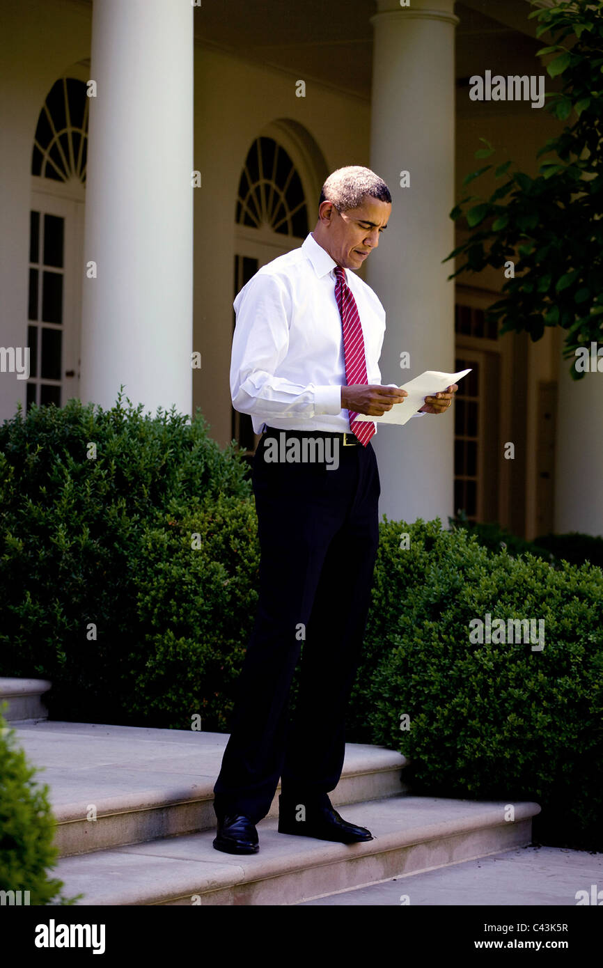 President Barack Obama reads a document outside the Oval Office on the ...