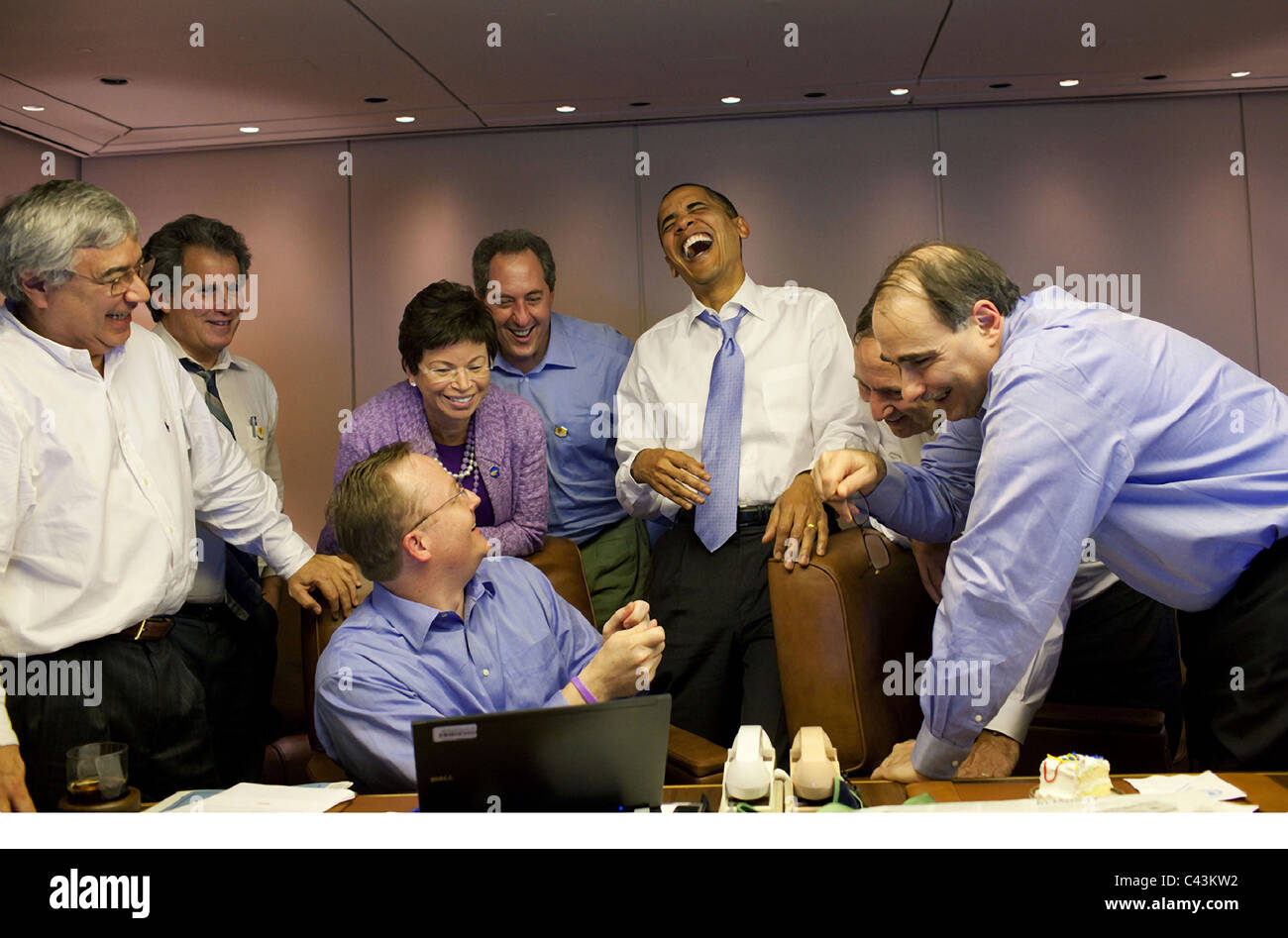 President Barack Obama shares a laugh with White House staff aboard Air ...