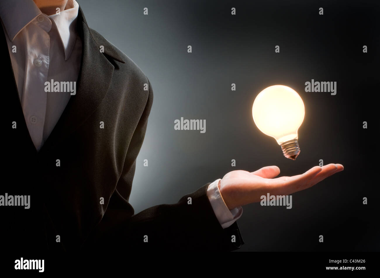 a man pointing to the illuminated bulb Stock Photo - Alamy