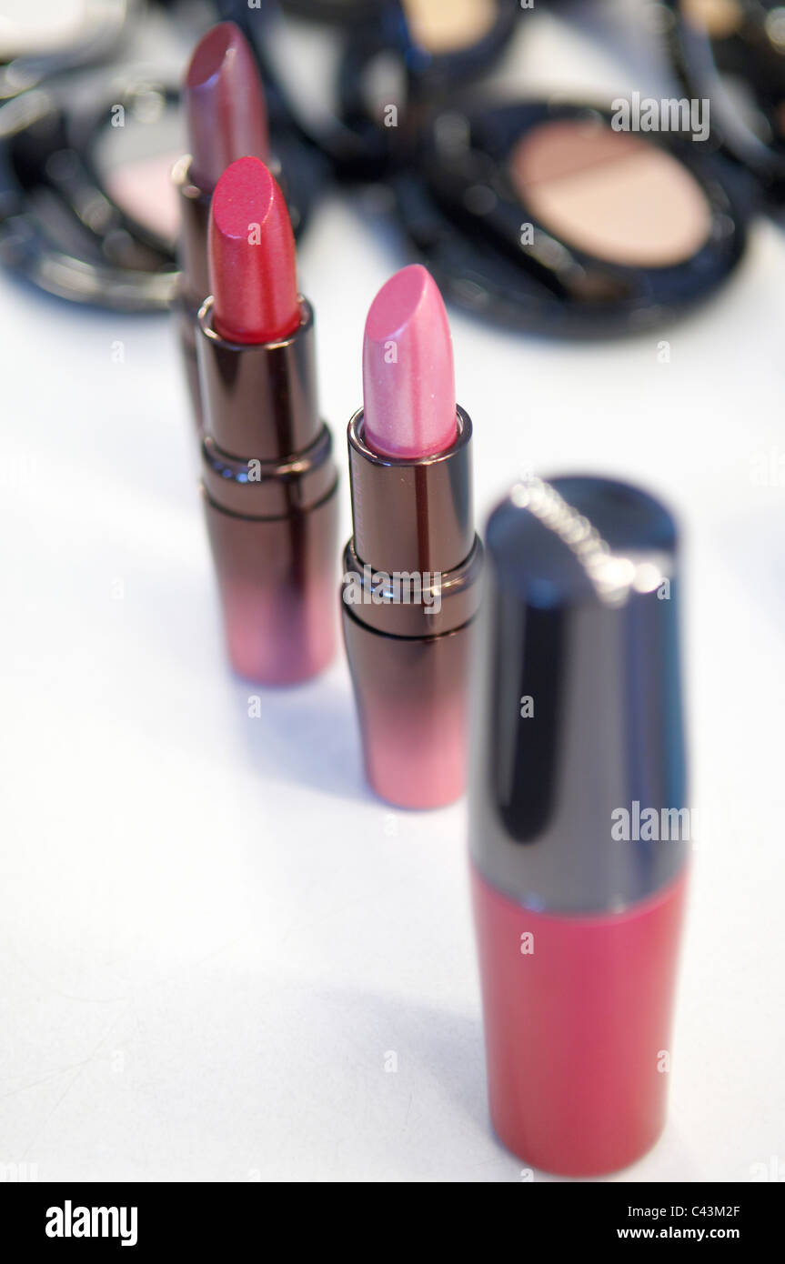 Still life of designer lipsticks on white table Stock Photo - Alamy
