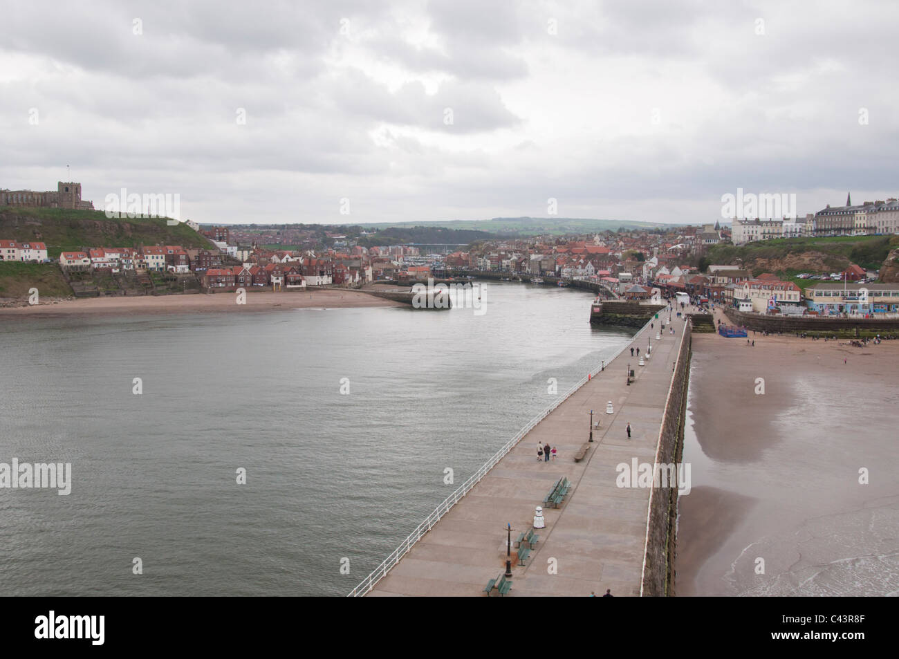 A general wide view of Whitby including harbour pier and town Stock ...
