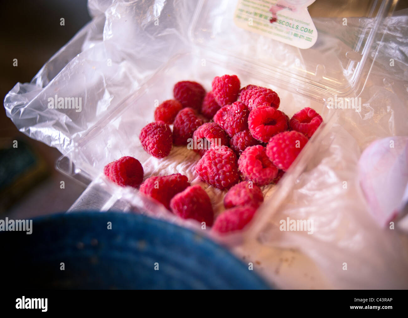 A container of raspberries is seen on a kitchen counter in New York on ...
