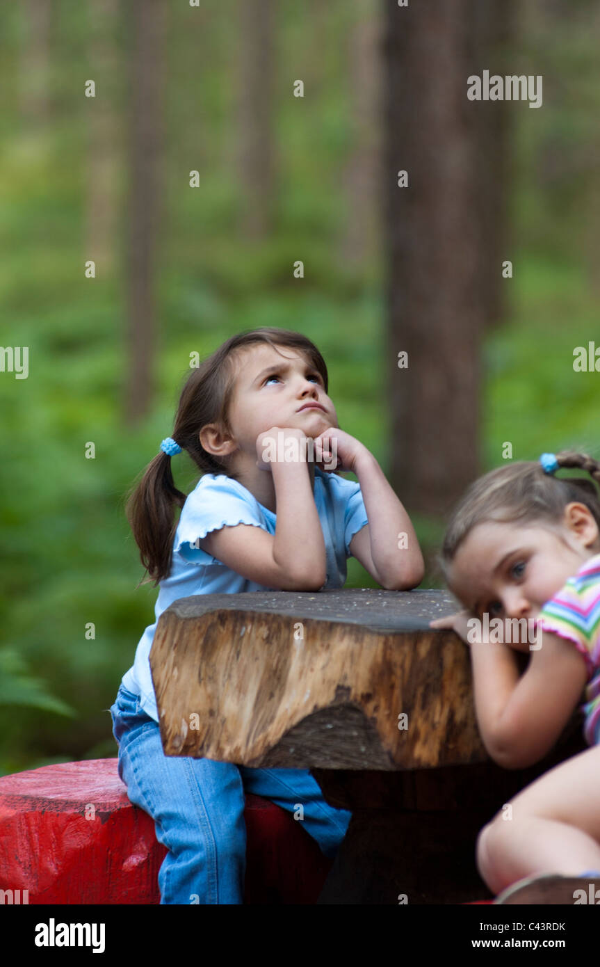 two young kids, girls sulking in the woods Stock Photo - Alamy