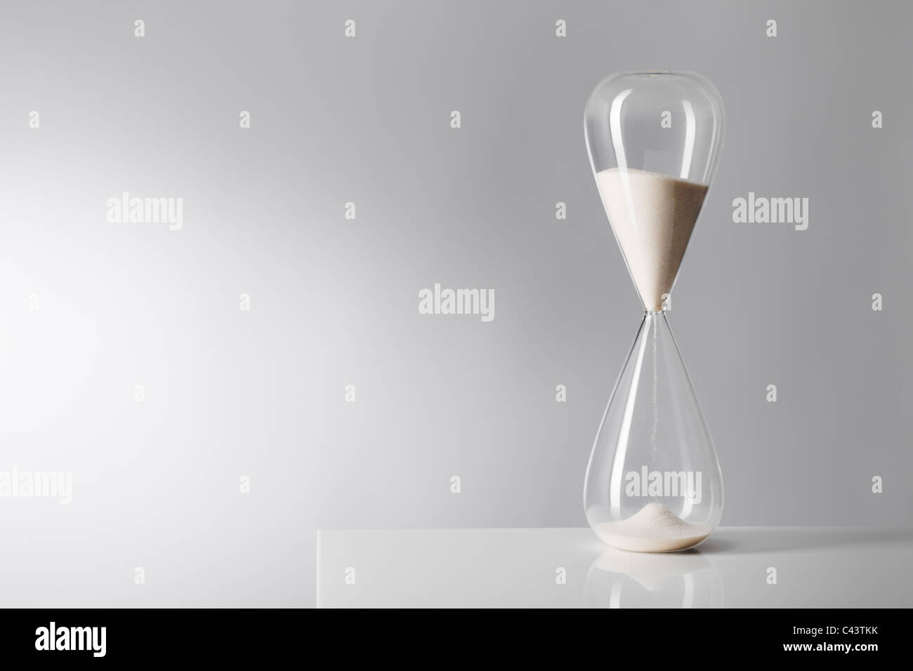 Studio photo of a hourglass on reflective table Stock Photo - Alamy